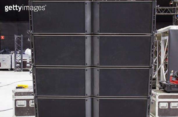 Stack of line array speakers. Installation of professional sound ...