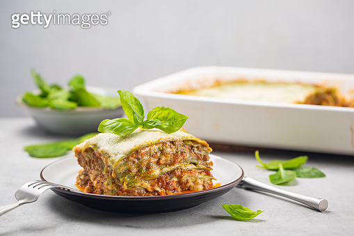 Homemade oven-baked green lasagna with spinach in the dough, ragu ...