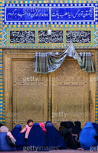 Afghan women in burkas - Shrine of Ali (Hazrat Ali Mazar) - gilded gate ...