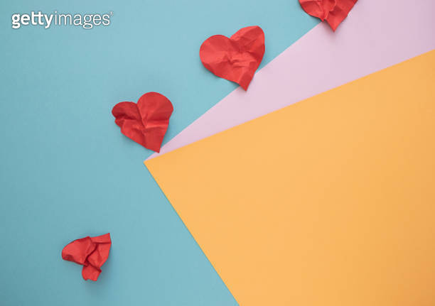 Valentine's Day love concept with red paper hearts lined up and falling ...