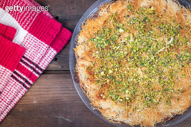 Kanafe arabic cheese cake dessert topped with with green almonds ...