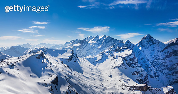 The background of Swiss Alps mountain with cloudy and blue sky of ...