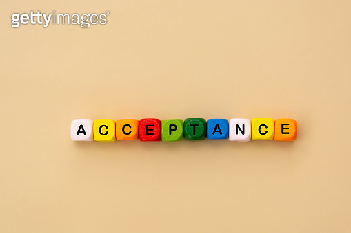 Acceptance text word, colorful wooden cubes. Inclusive and tolerance ...