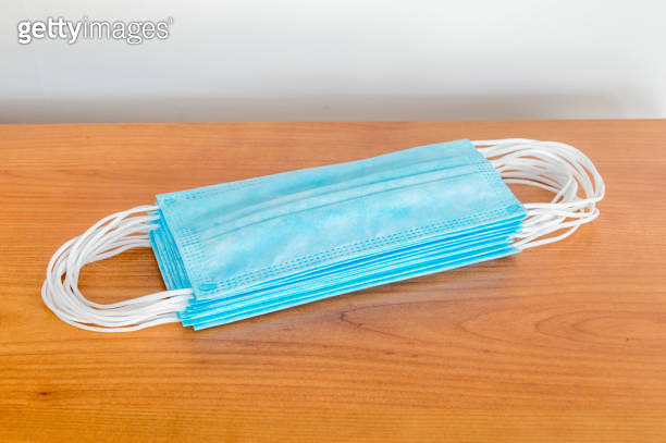 Surgical masks with rubber ear straps. Stack of antiviral medical mask ...