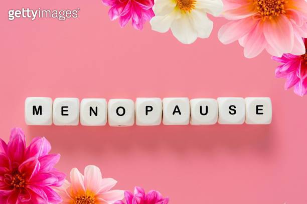 Menopause word abstract text, wooden blocks with dahlia flowers, over ...