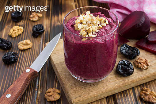 Puree with beets, walnut, prunes and ingredient on the wooden cutting ...