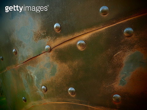 Metal surface with rivets and bolts. Abstract background of a military ...
