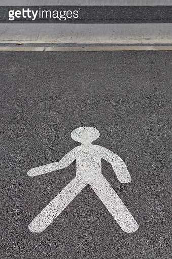 Walking pedestrian crossing sign painted in white on the ground ...