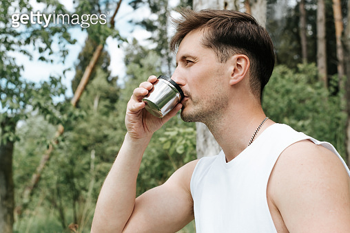 Camping outdoors. Man having a rest in nature, close-up. Cheerful young ...