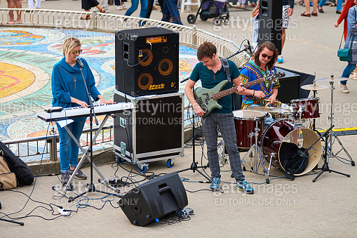 Musicians performance outdoor, playing bass guitar, drums and ...