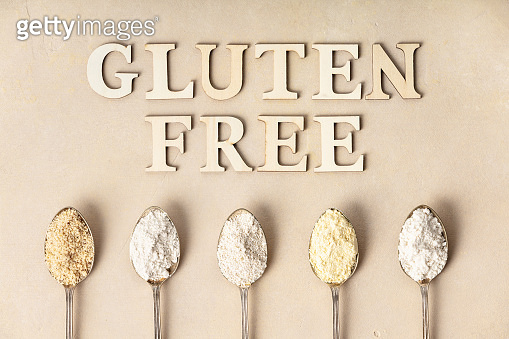 Metal spoons of various gluten free flour (almond flour, oatmeal flour ...