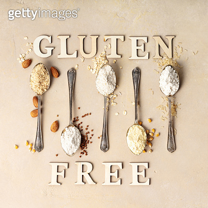 Metal spoons of various gluten free flour (almond flour, oatmeal flour ...