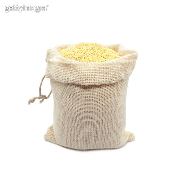 Millet in burlap sack isolated on white background. Raw yellow millets ...