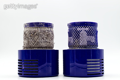 Massively clogged dirty filter and a new clean filter of a cordless ...