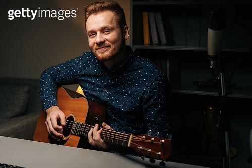 Vertical portrait of smiling guitarist singer man play on acoustic ...