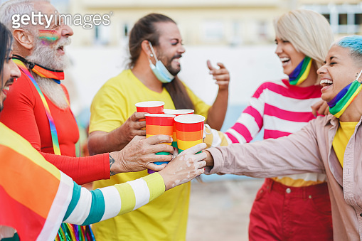 Multi generation people have fun together at gay pride parade and ...