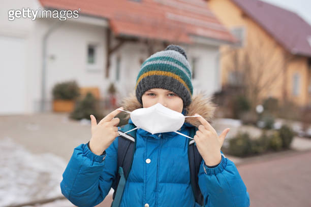 Kid boy wearing ffp medical mask on the way to school. Child backpack ...