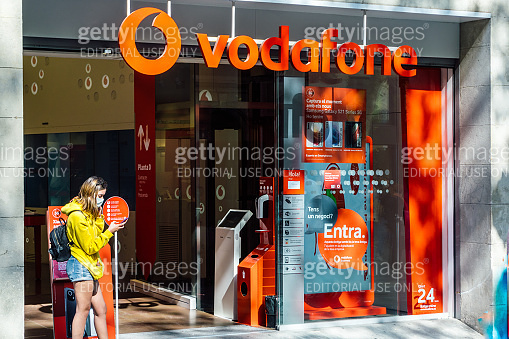 Logo and facade of Vodafone mobile phone operator, multinational ...