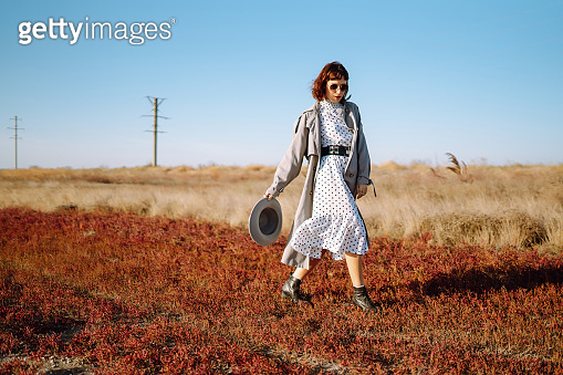 Stylish woman enjoys nature. Spring fashion. People, freedom, lifestyle ...