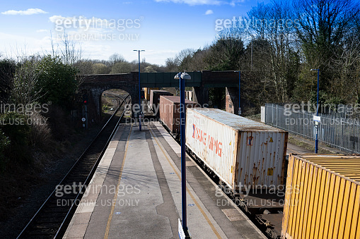 A freightliner locomotive is pulling a goods / freight train with ...
