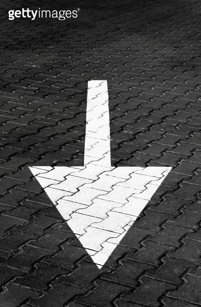 Large White arrow symbol painted on the road. asphalt road with drawn ...