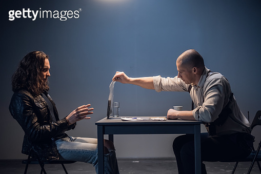 A detained white man with long hair receives irrefutable evidence of his guilt from a criminal ...