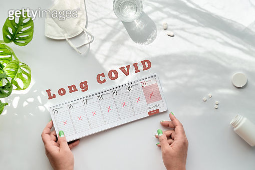 Text Long Covid, patient hands hold weekly planner, calendar with all ...
