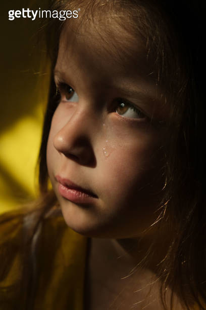 Dramatic portrait of sad little child girl with tear on the cheek and ...