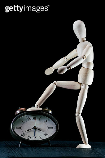 wooden dummy and analogic clock, time concept, puppet made of wood, art ...