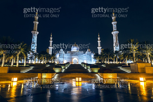 Sheikh Zayed Grand Mosque front view from plateau illuminated by night ...