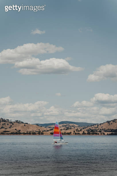 A yacht or boat sailing on Lake Hume with beautiful mountain views in ...