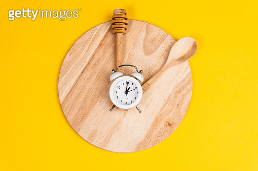 alarm clock with a spoon shows the time of the lunch break. lunch break ...