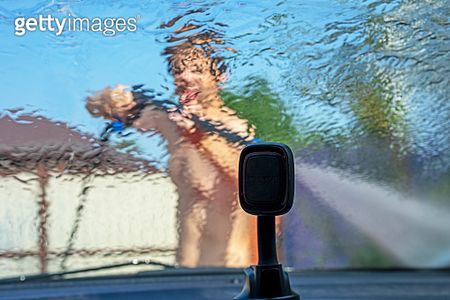 look through the blurred windshield of a car at a heavy downpour, flood ...