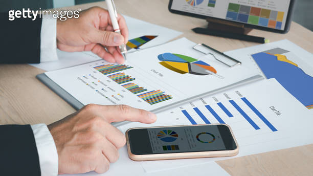 Preparing report. Green and red graphs and charts. Business reports and ...