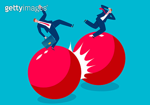 Two businessmen stand on the ball out of control and collide together ...