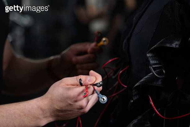 Wires from EMS suit in gym. Sport training in electrical muscle ...