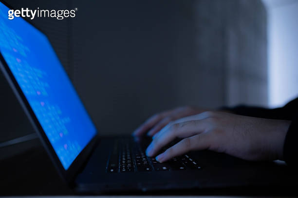 close up programmer man hand typing on keyboard at laptop to input code language into software ...