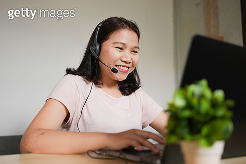 close up young call center employee woman wear headset to talking with ...