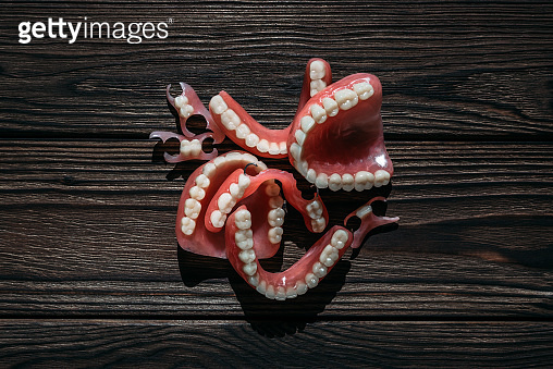 Dentures on a dark background. Close-up of dentures. Dentistry is ...