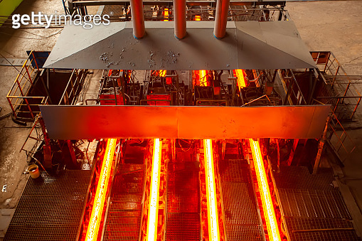 Steelmaker at ingot casting. steelworker at work pouring metal in the ...