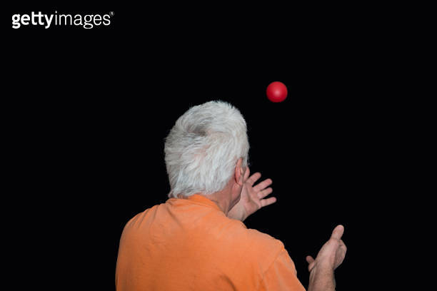 Parkinson Disease patient, standing and juggling with a little ball in ...