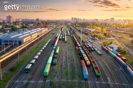 Aerial view of freight trains at sunset. Top view of railway station ...