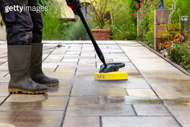 Cleaning stone slabs on patio with the high-pressure cleaner. 이미지 ...
