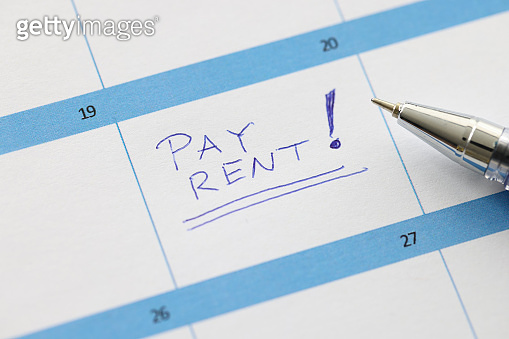 Pay rent is written on sheet of calendar with ballpoint pen closeup ...