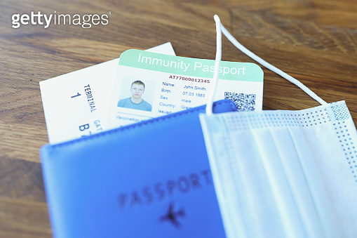 Immunity passport and protective medical mask with plane ticket is on ...