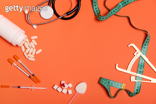 Flat lay of white refined sugar with blood drop, caliper, measuring ...