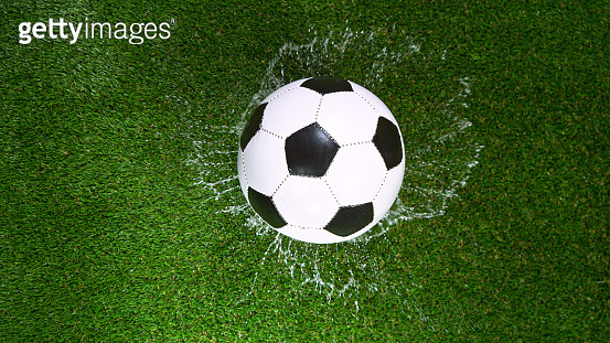 Close-up of Falling Soccer Ball on Green Grass, Water Splash ...