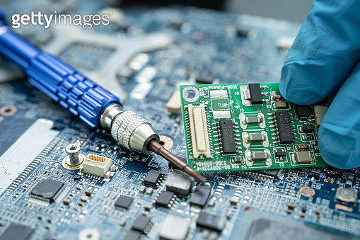 Repairing inside of hard disk by soldering iron. Integrated Circuit ...