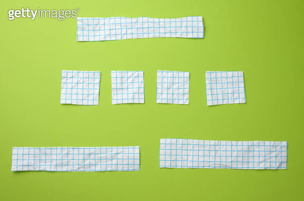 various pieces of white paper in a blue cage on a green background 이미지 ...