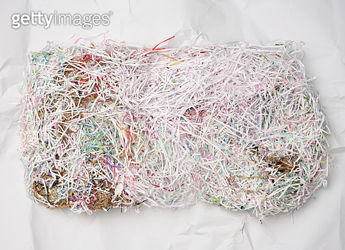 cut paper sheets into small strips, waste. Fragile packaging paper ...